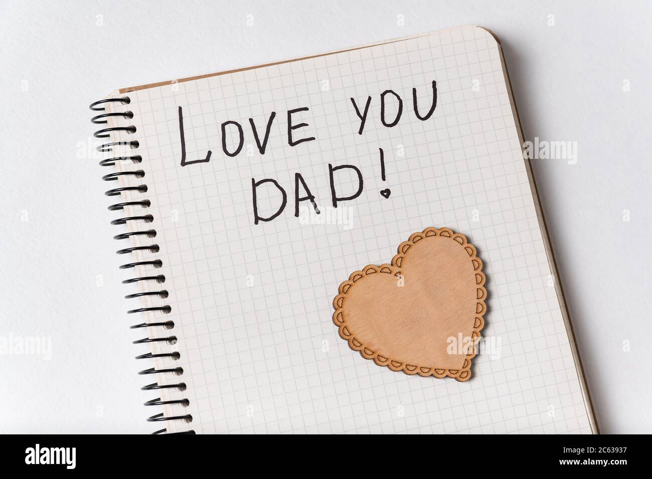 Cute inscription in notebook I LOVE YOU DAD. Close-up notepad and heart ...