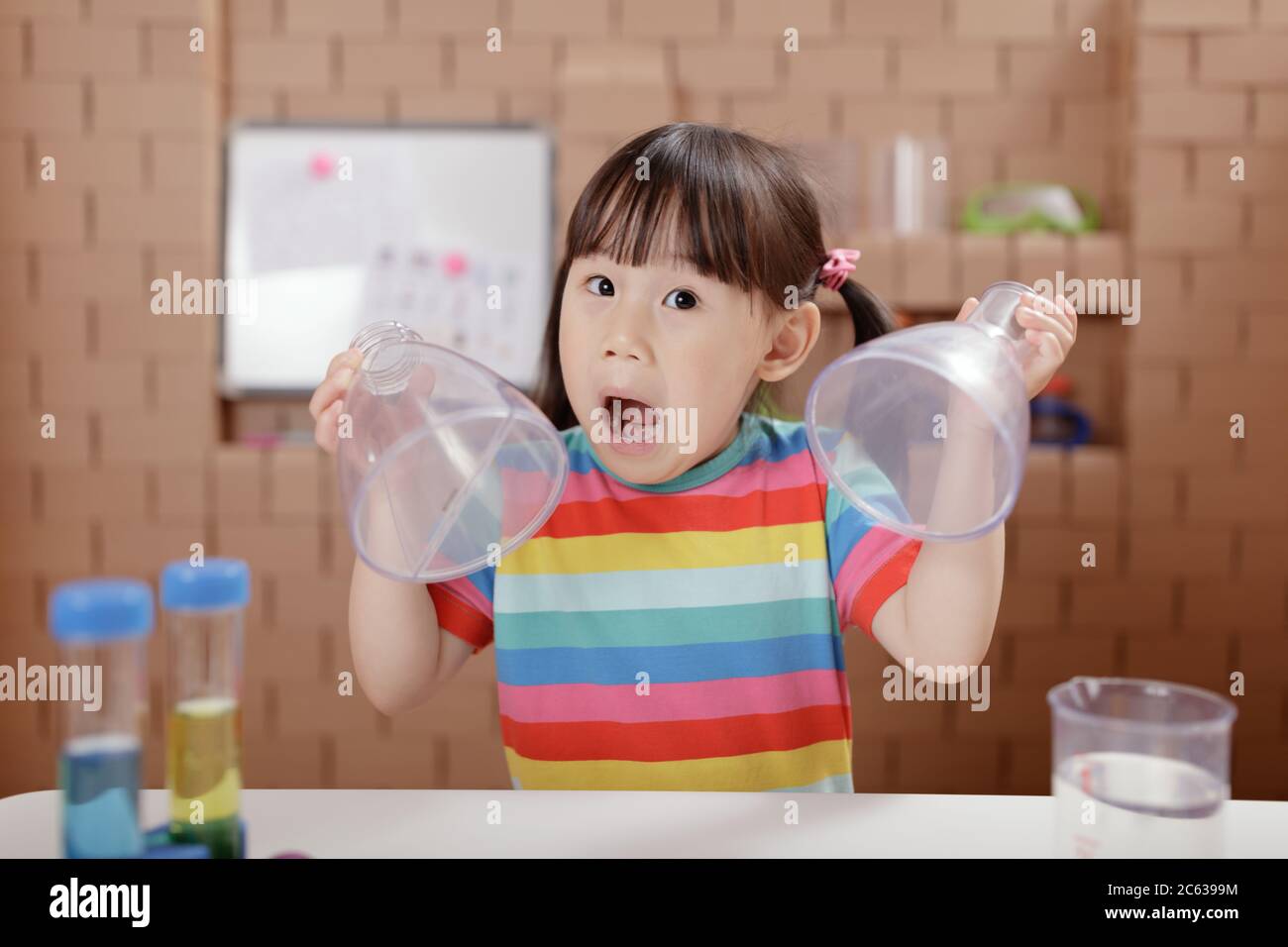 portrait of cute girl with Mouth and eyes wide opening during play ...