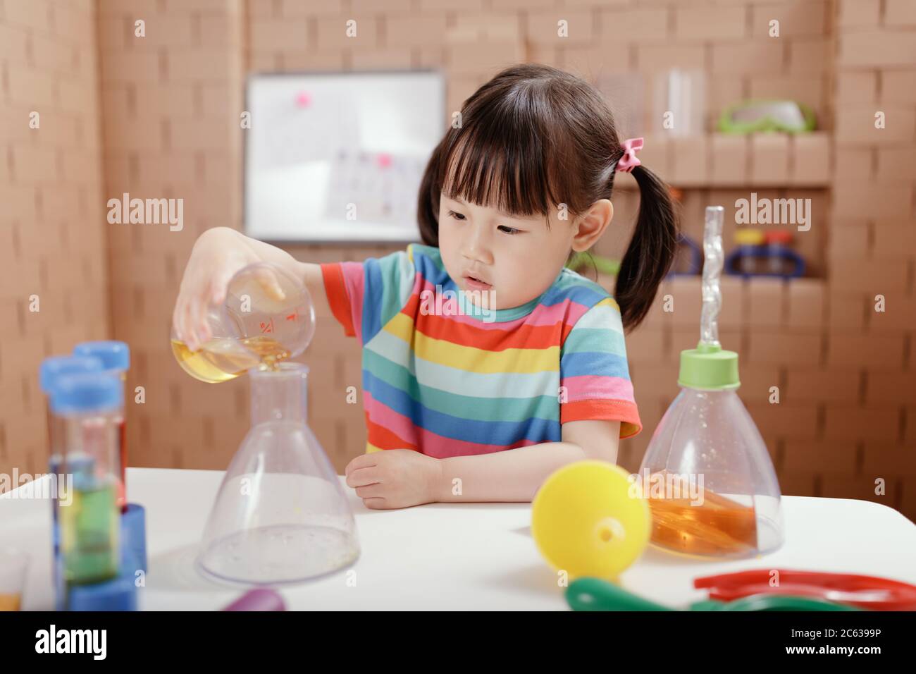 toddler girl play science experiments for homeschooling Stock Photo - Alamy
