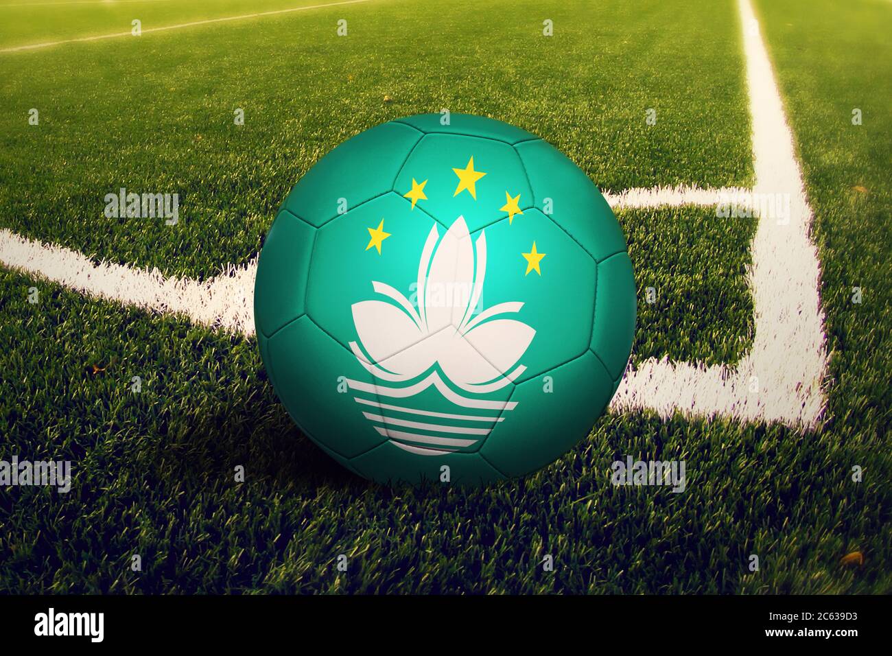 Macao flag on ball at corner kick position, soccer field background ...