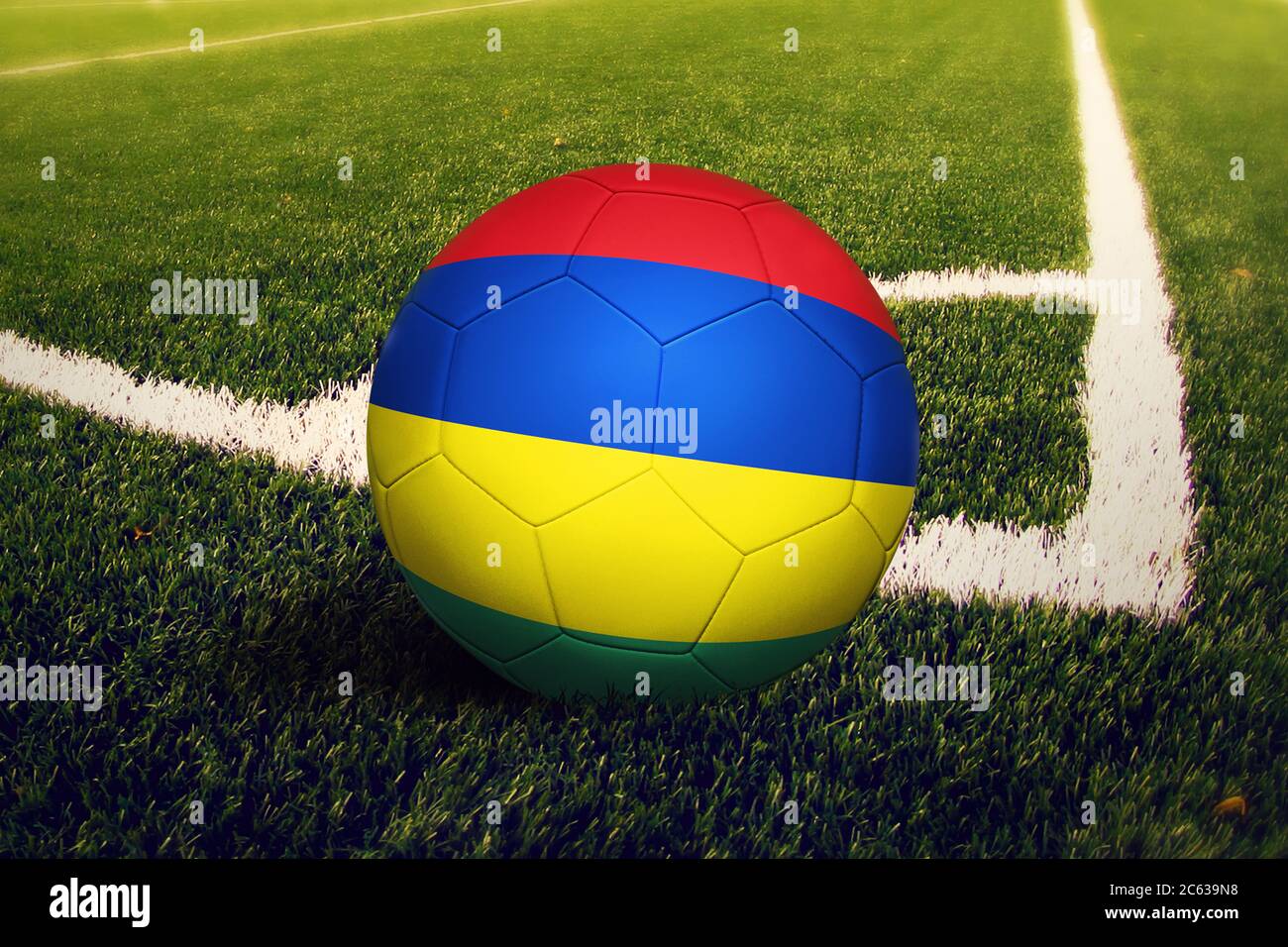 Mauritius flag on ball at corner kick position, soccer field background ...
