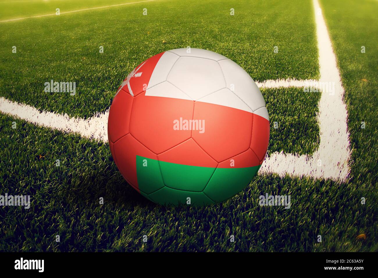 Oman flag on ball at corner kick position, soccer field background ...