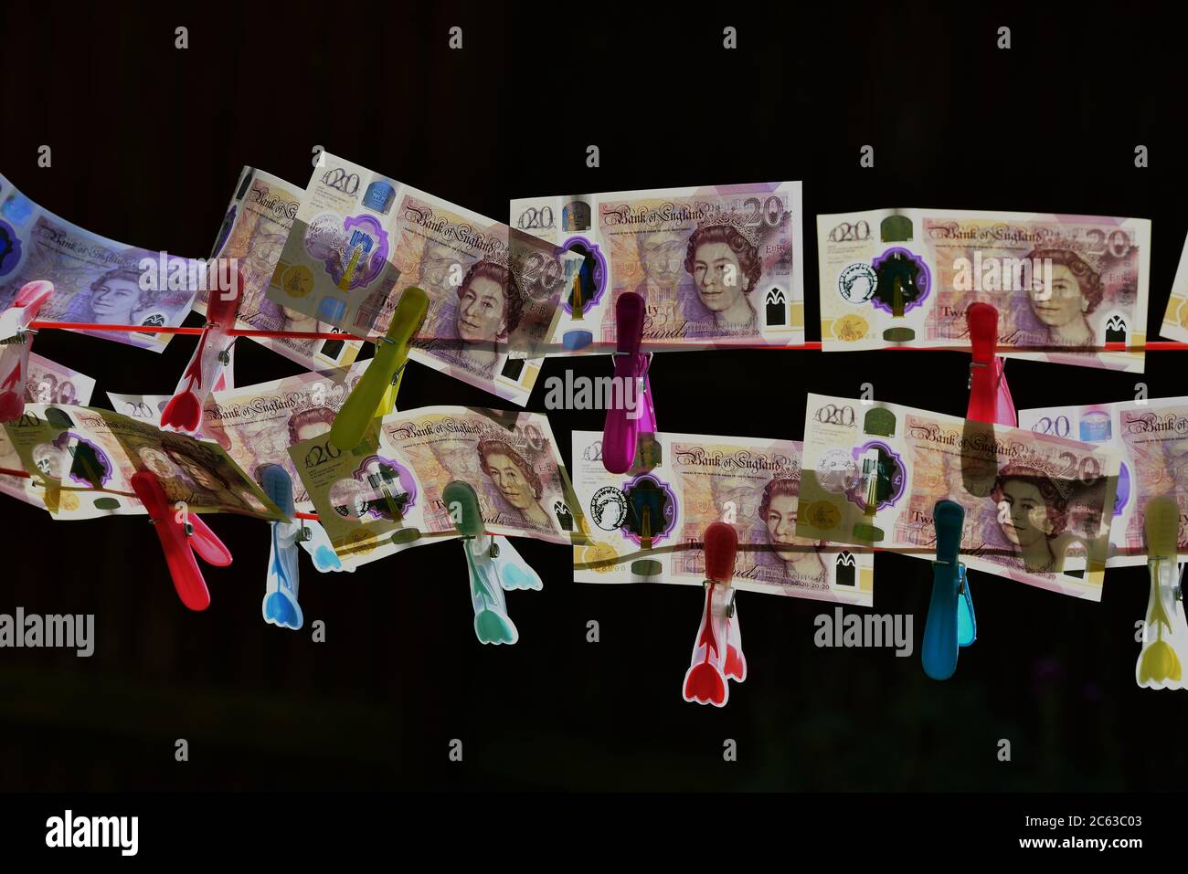 Picture shows twenty pounds notes on a washing line. Can be used for an ...