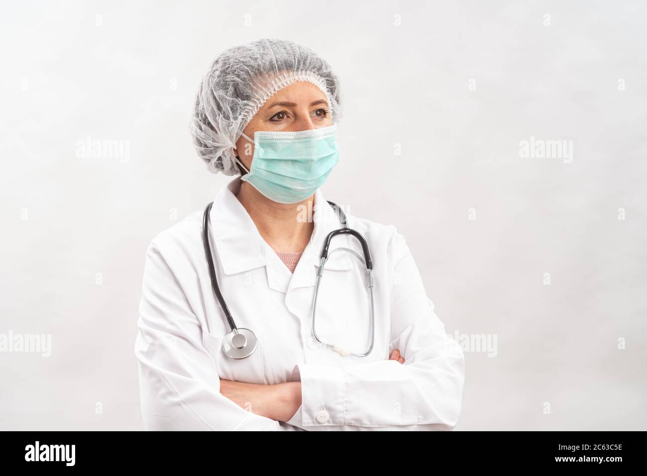 Tired female medic, nurse in protective equipment and a mask from ...