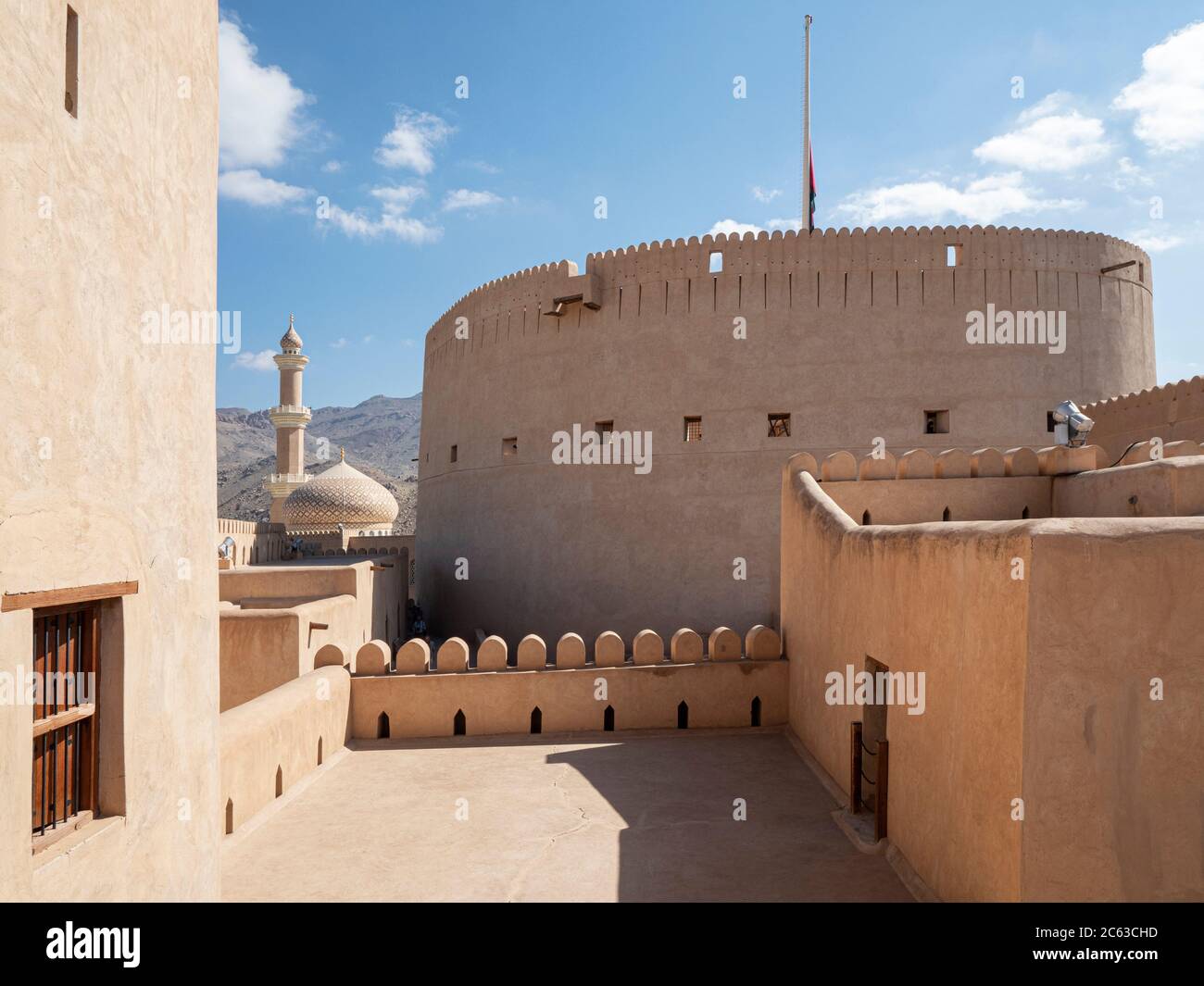 The Sultan Qaboos Mosque, raising above the Nizwa Fort, Nizwa ...