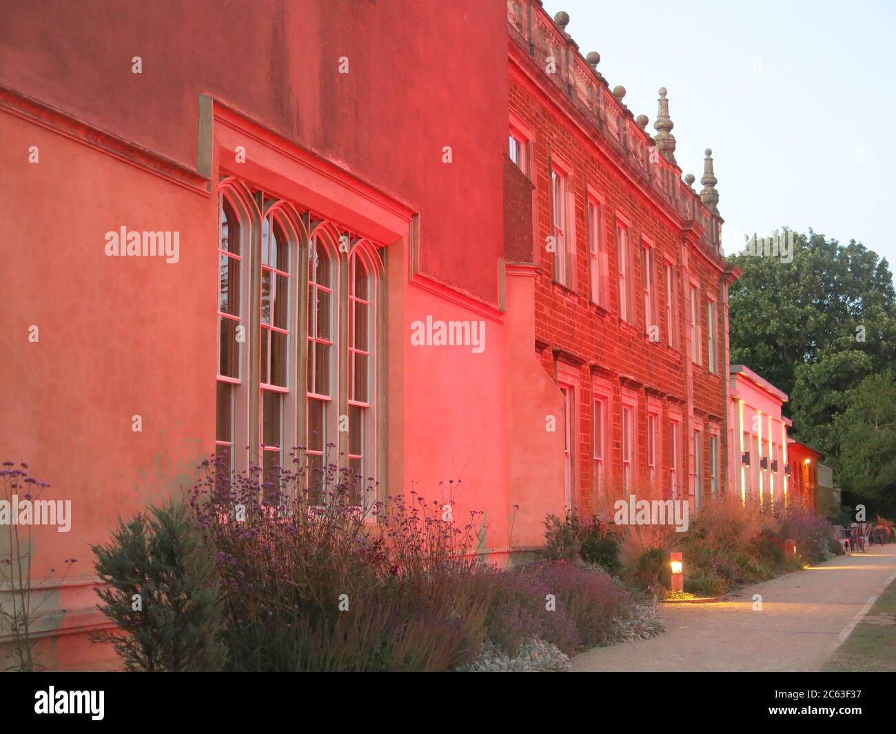 Facade of Delapre Abbey in Northampton at dusk, faintly illuminated in ...