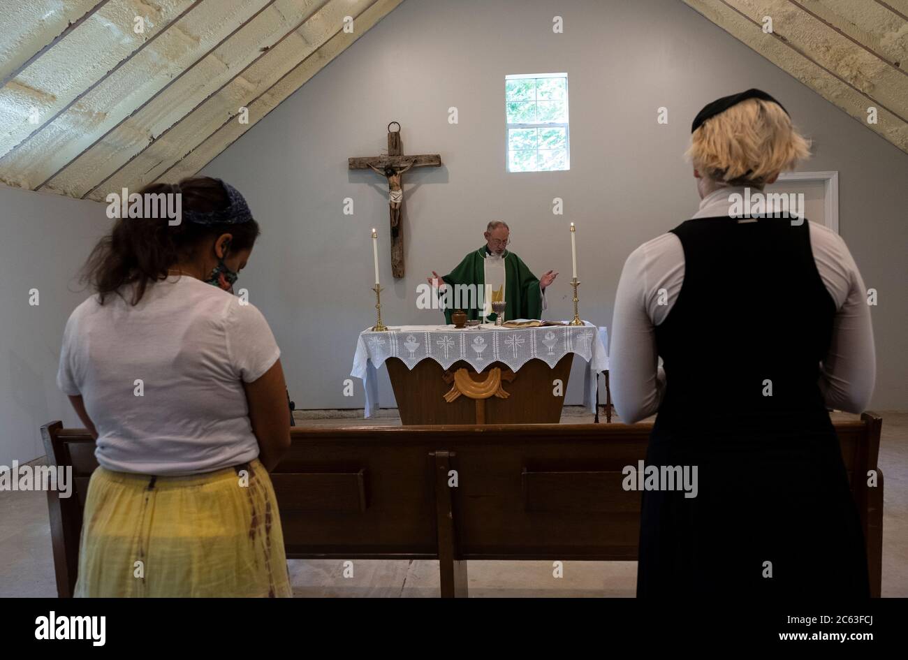 Priest saying Mass in a barn during pandemic Stock Photo - Alamy