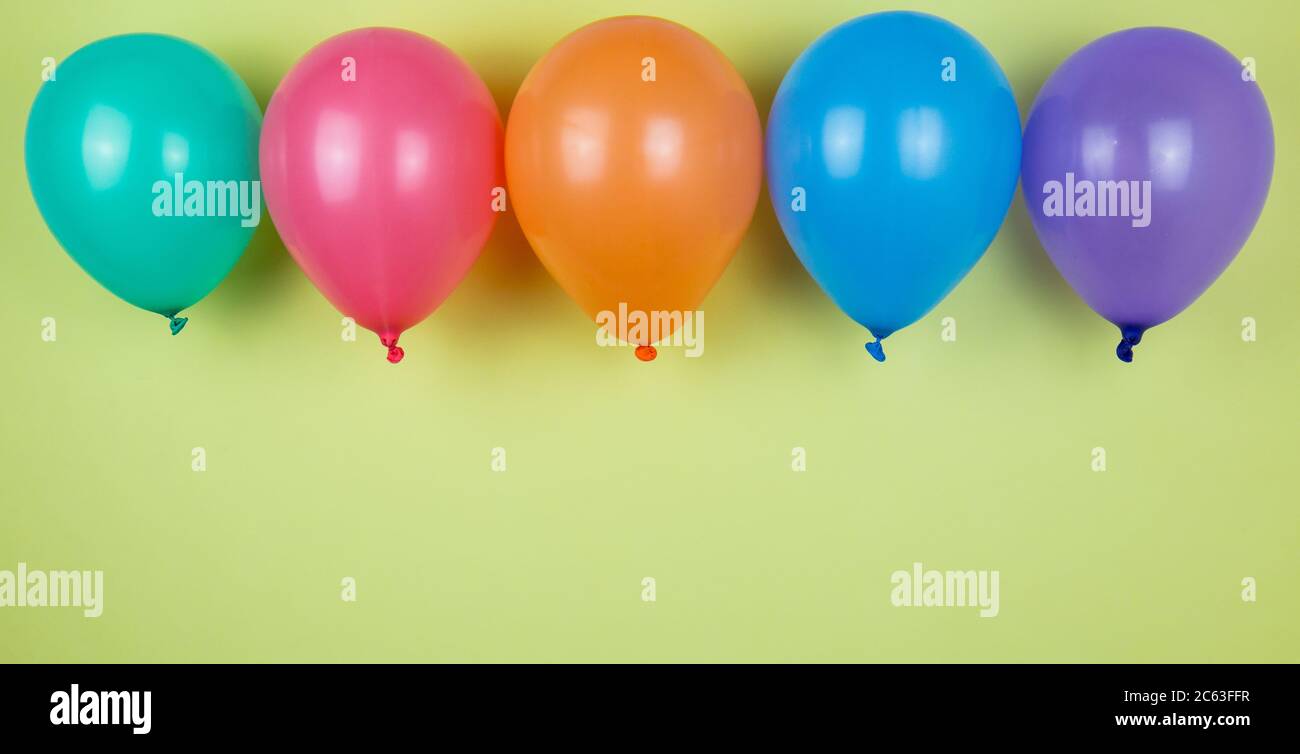 Different colors of balloons. Balloons on a yellow background Stock ...
