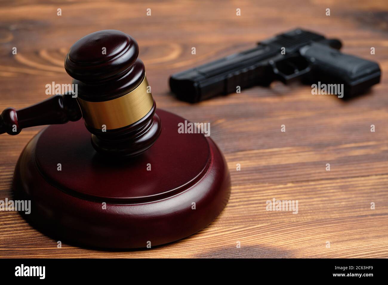 Judge hammer on a background of the gun as a concept court sentence for ...