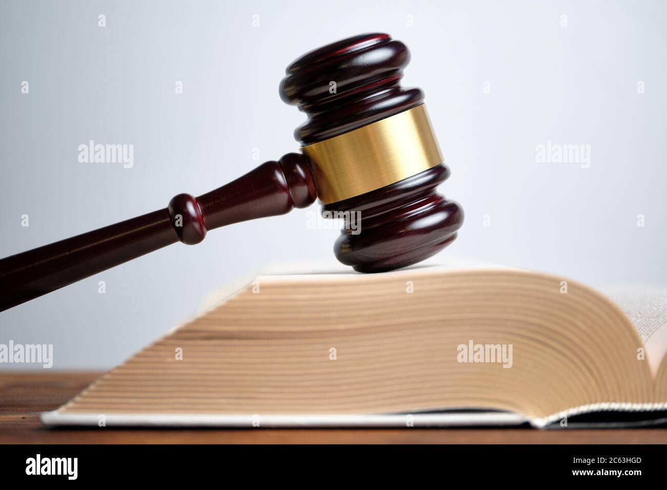 Judge hammer on the book with the laws on a white background Stock ...