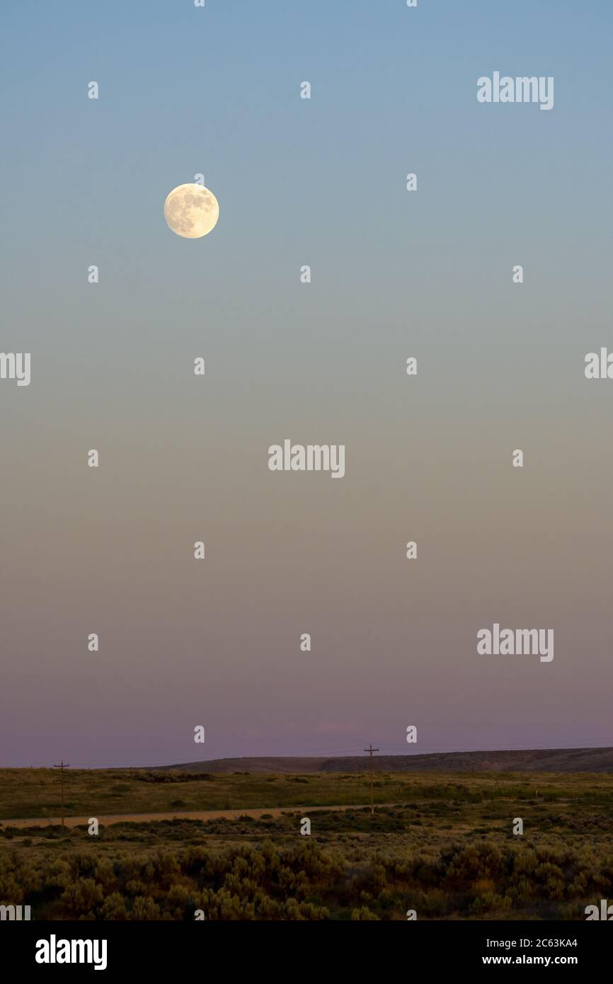 Sunset moon rise over high desert Stock Photo - Alamy