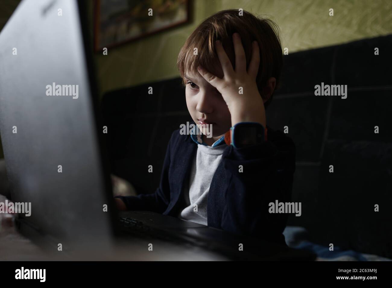focused child sitting at a computer Stock Photo - Alamy
