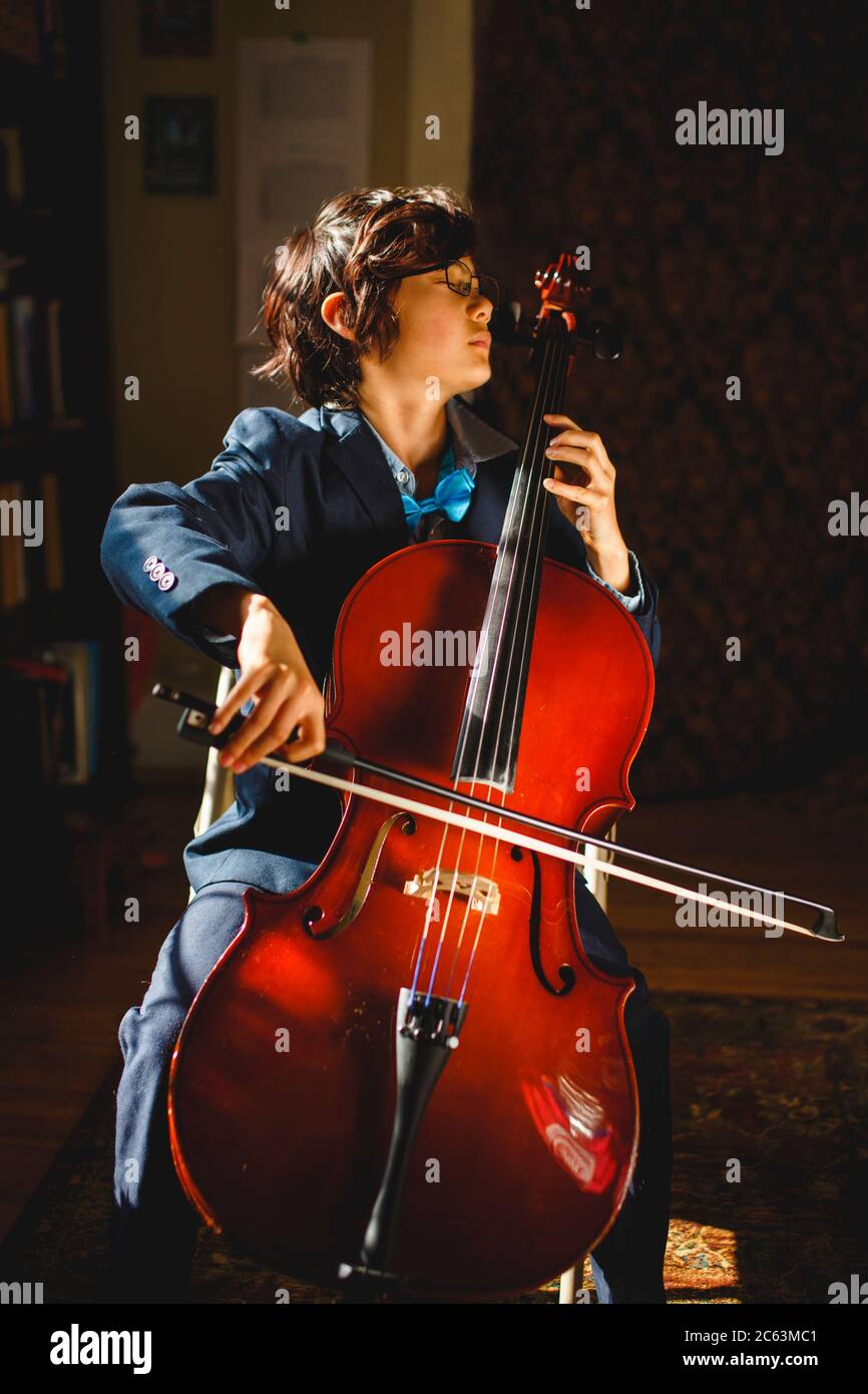 Boy playing cello hi-res stock photography and images - Alamy