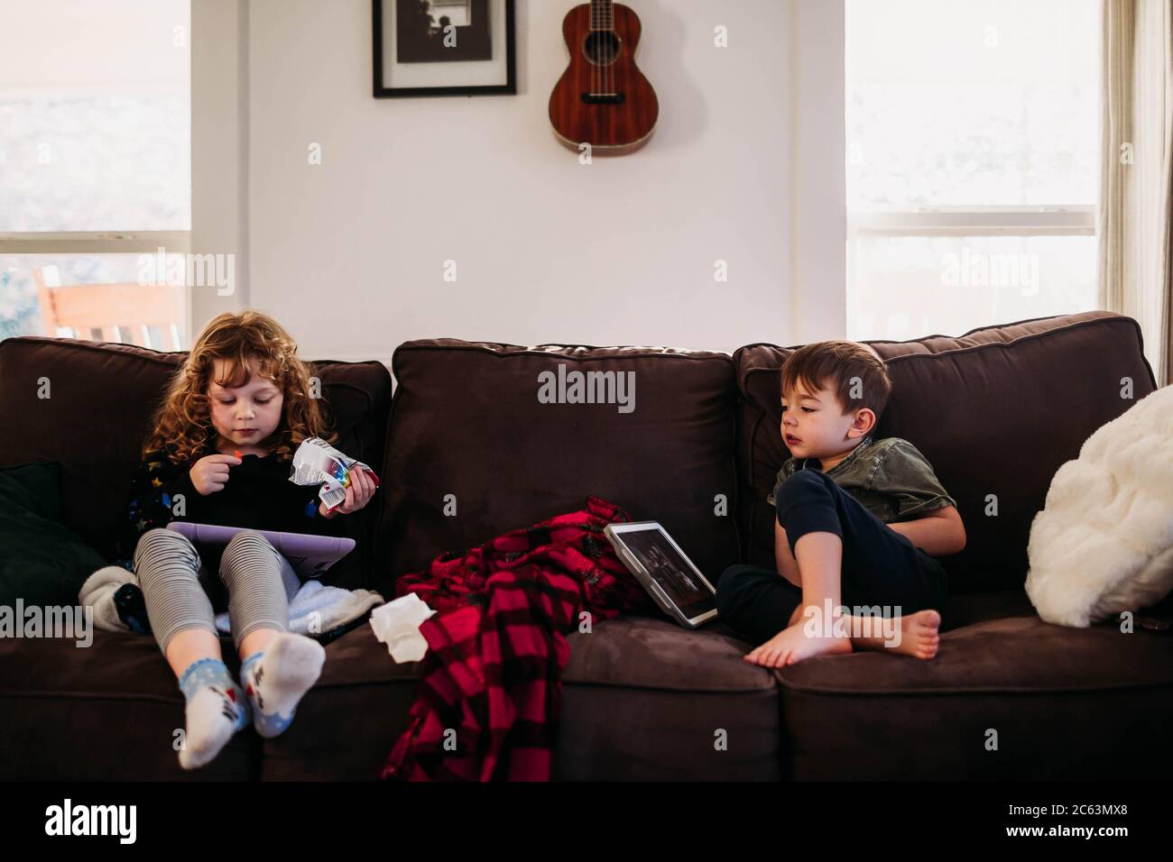 Young sister and brother home sick from school with flu Stock Photo - Alamy