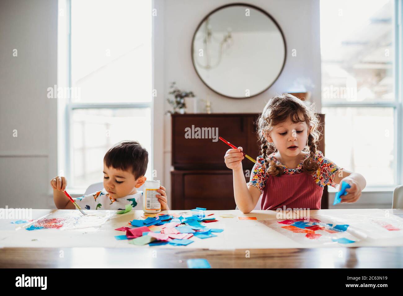Brother and sister creating art together at home in spring Stock Photo ...