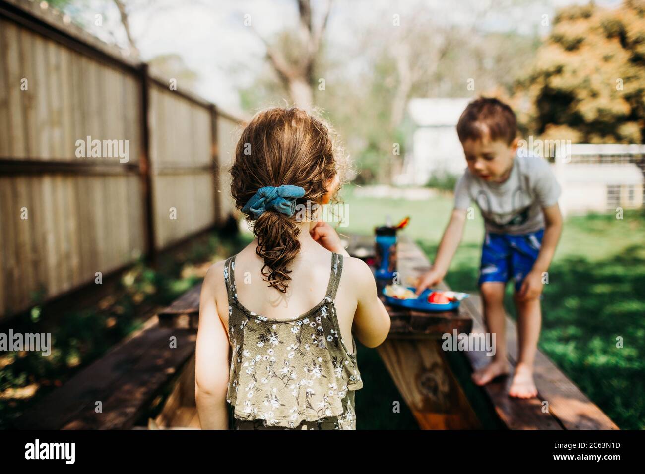 Two preschool age kids eating lunch outside at home Stock Photo - Alamy