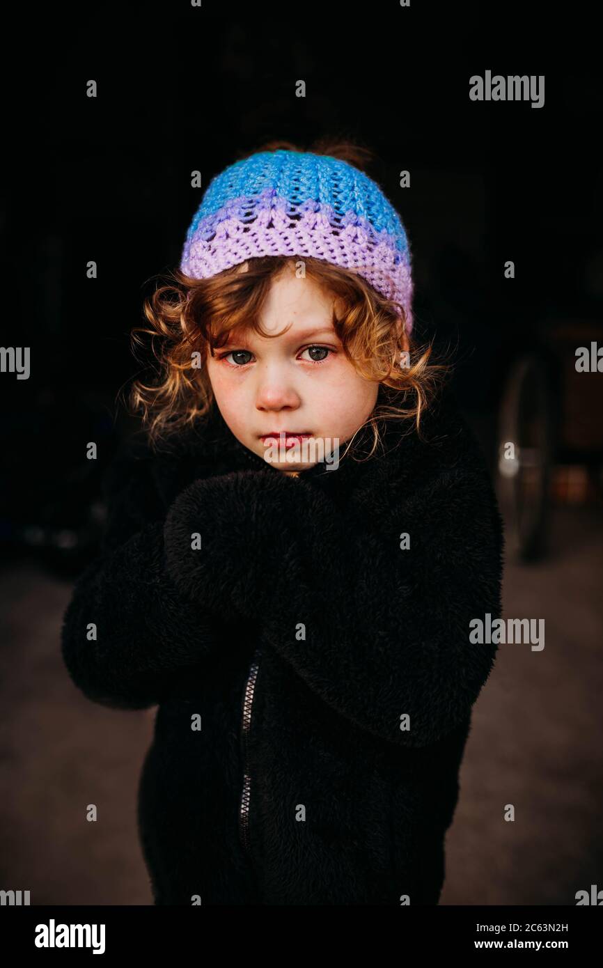 Young girl standing outside crying during winter Stock Photo - Alamy