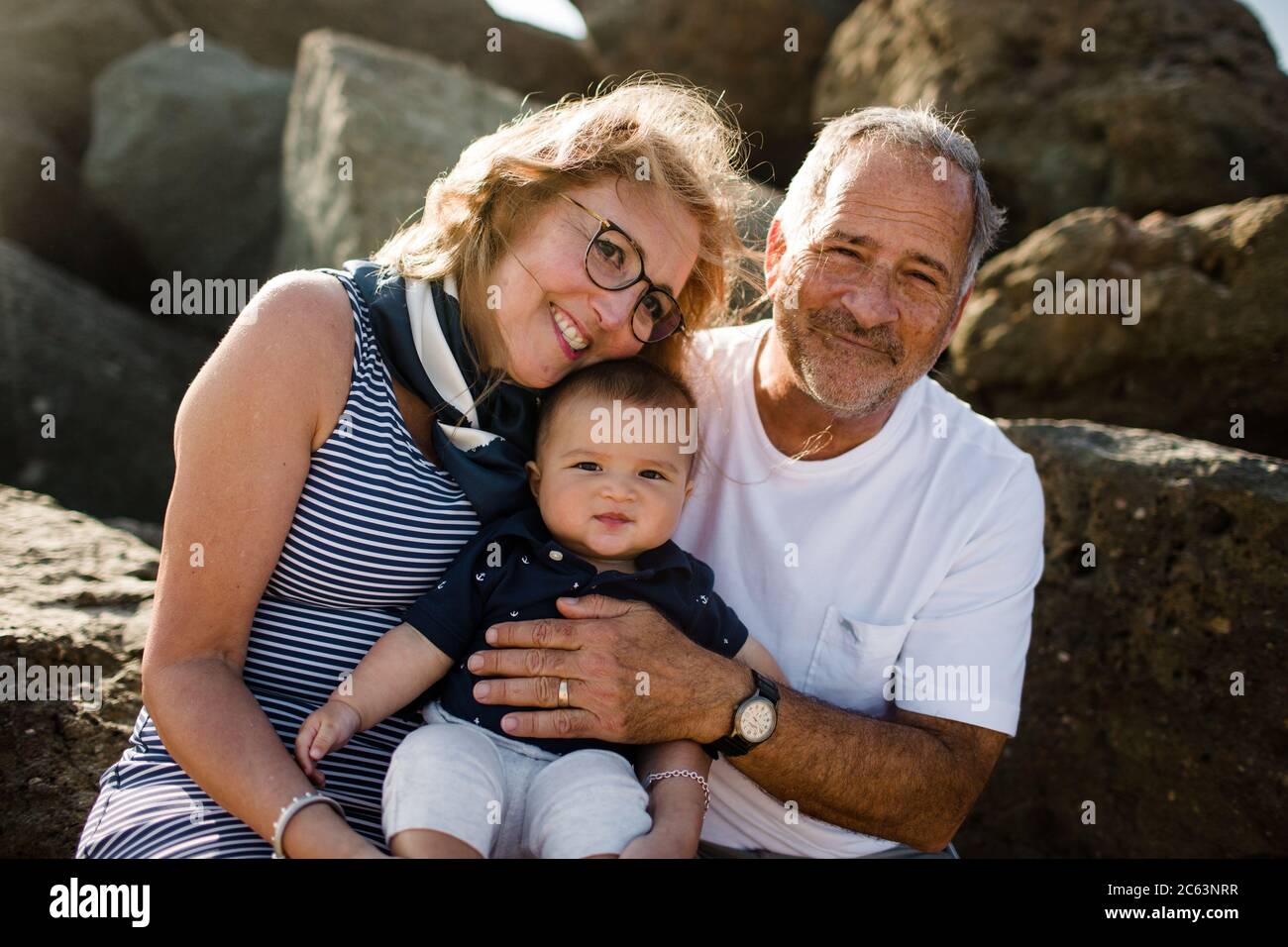 Grandparents Holding & Hugging Grandson Stock Photo - Alamy