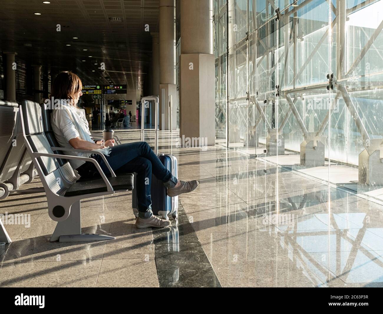 Pretty, young woman waiting at a gate area of a modern airport Stock ...