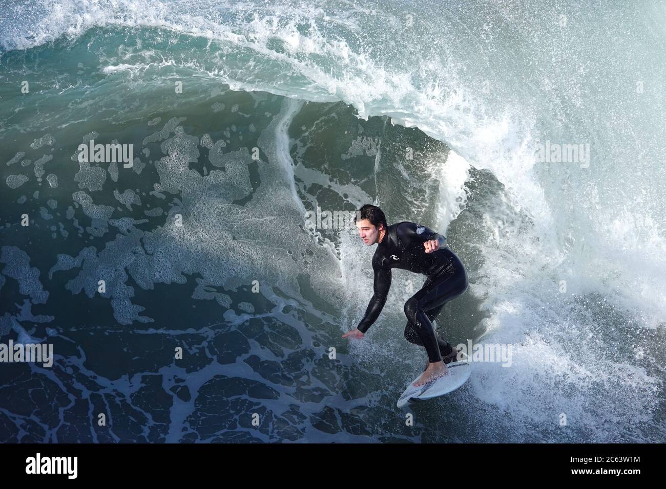 Young male surfer riding a large wave Stock Photo - Alamy