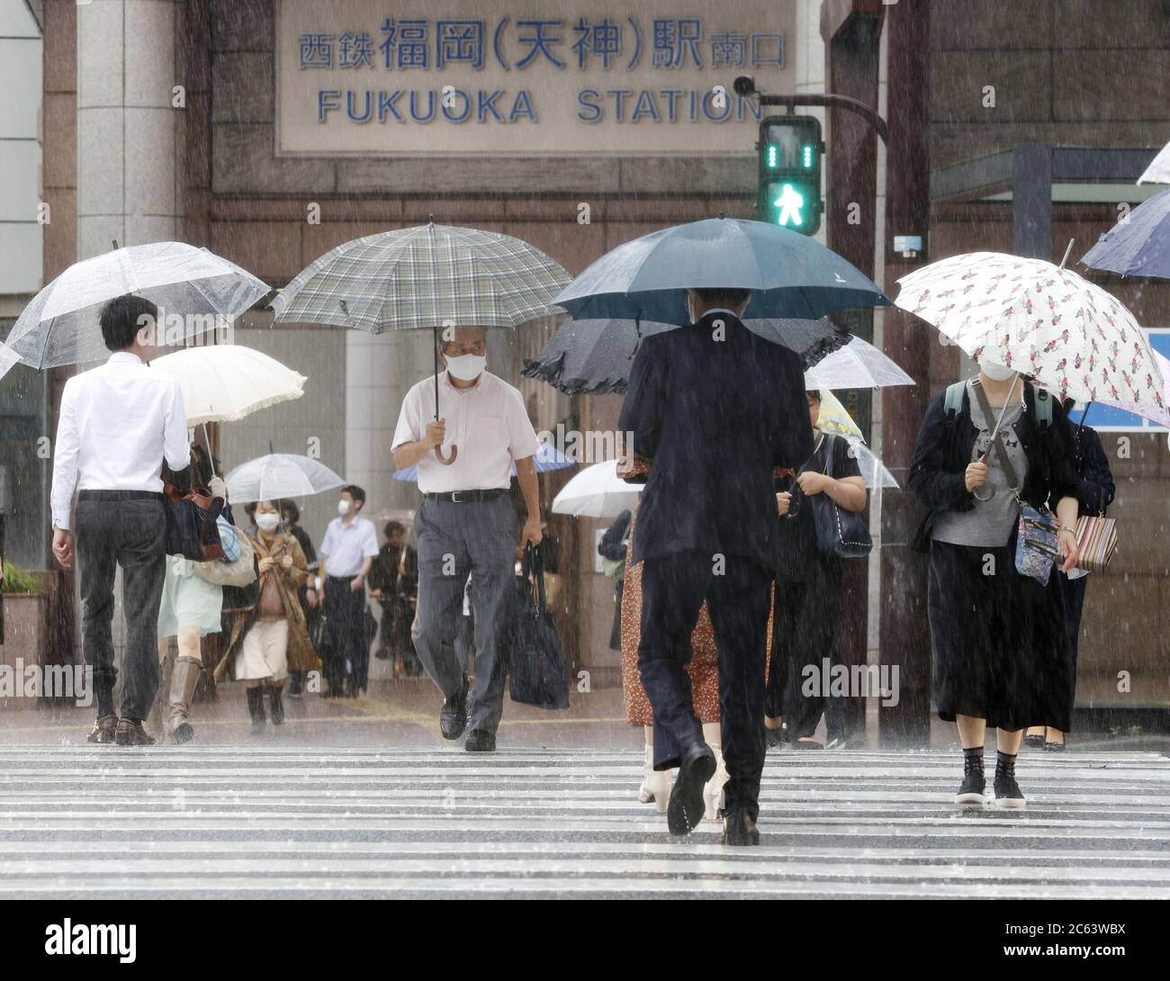 Japan. 7th July, 2020. Japan. 7th July, 2020. People walk under ...