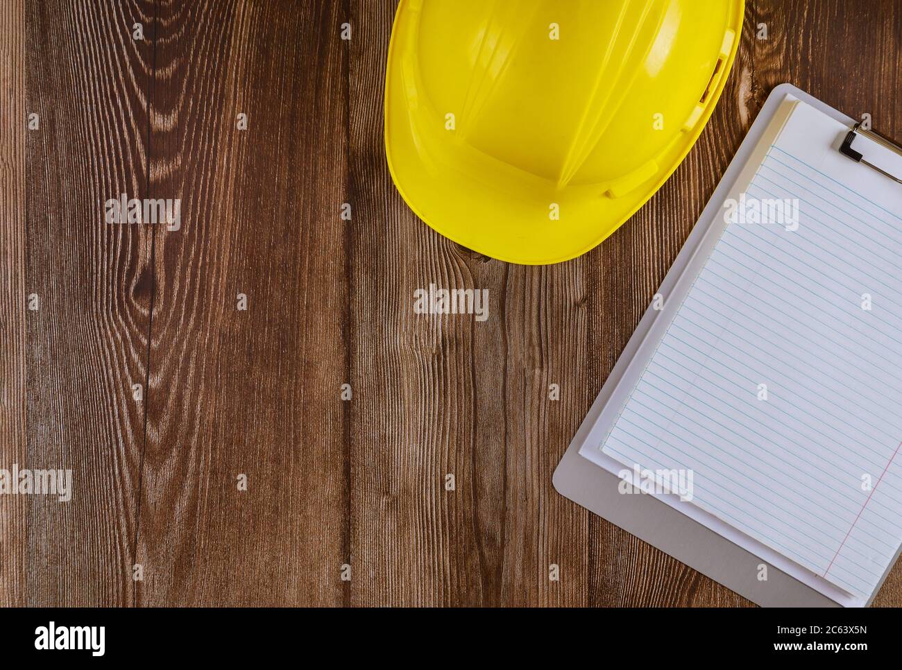 Engineer working on office desk with blank notebook construction ...