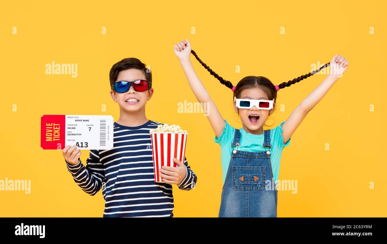 Adorable boy and girl having fun watching movies together on isolated ...