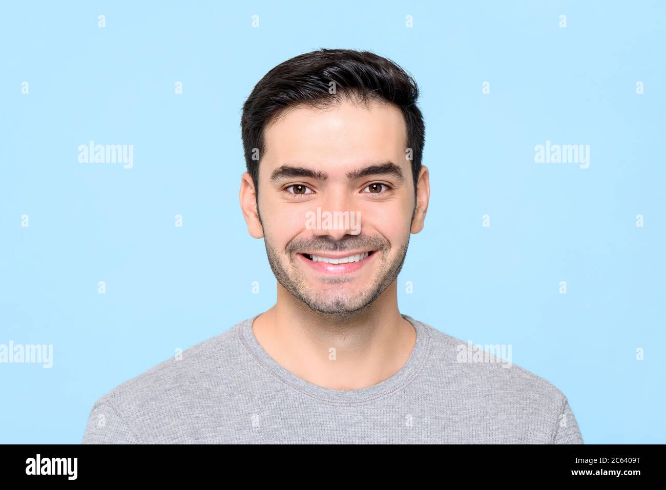 Friendly handsome smiling Caucasian man isolated light blue background ...