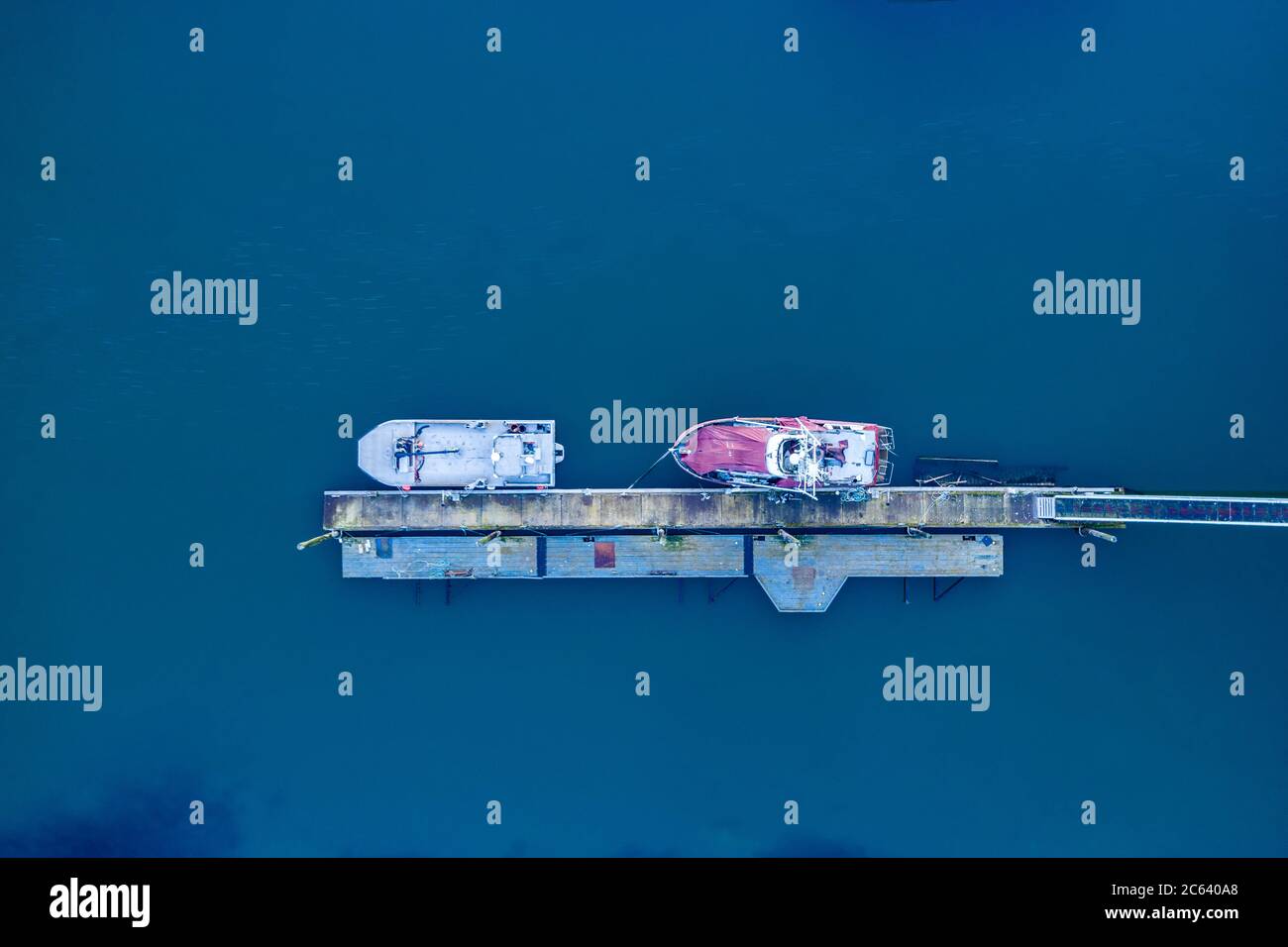 Top down view of two boats docked on pier Stock Photo - Alamy