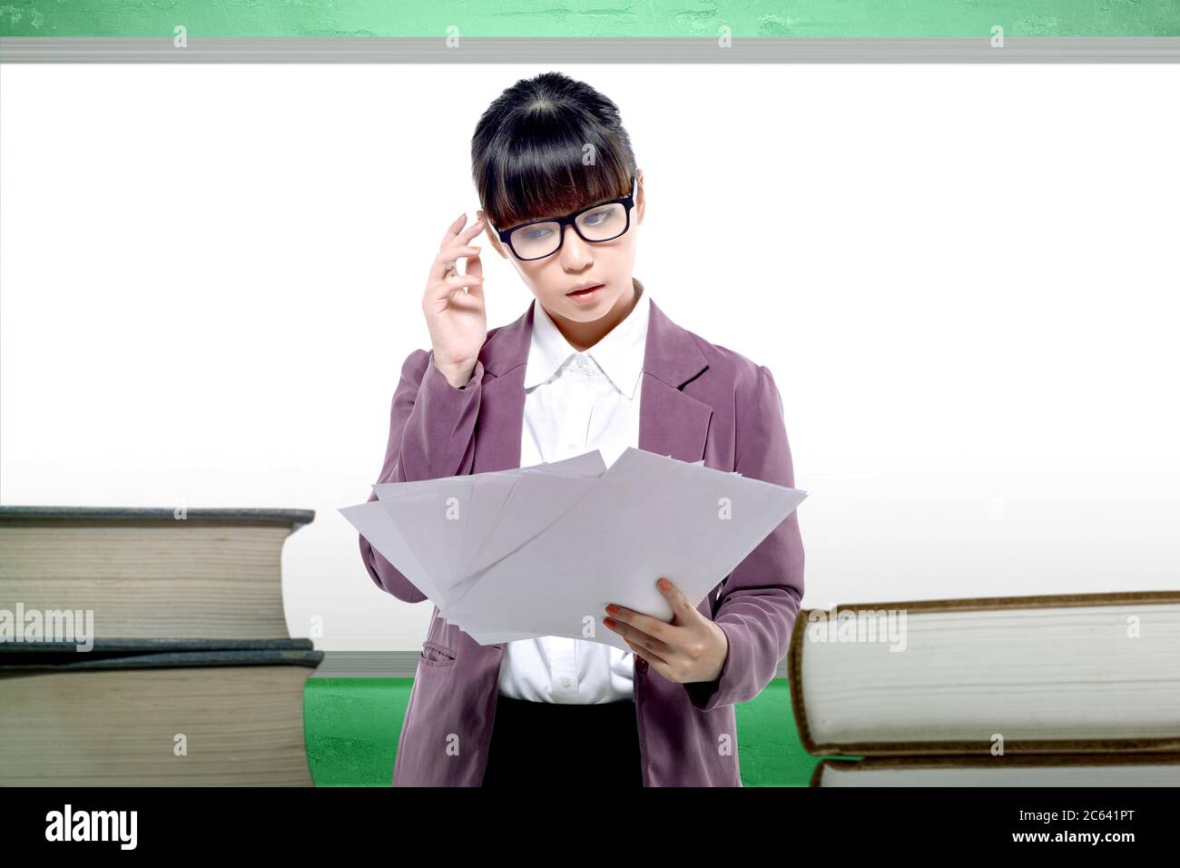 Asian teacher woman with papers standing in the classroom with a ...