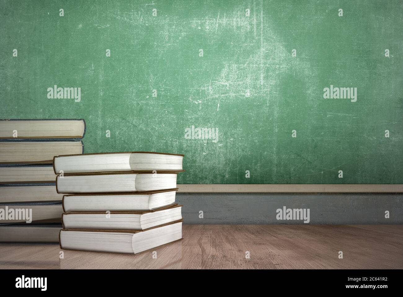 Desk with a stack of books with a chalkboard background. Back to School ...
