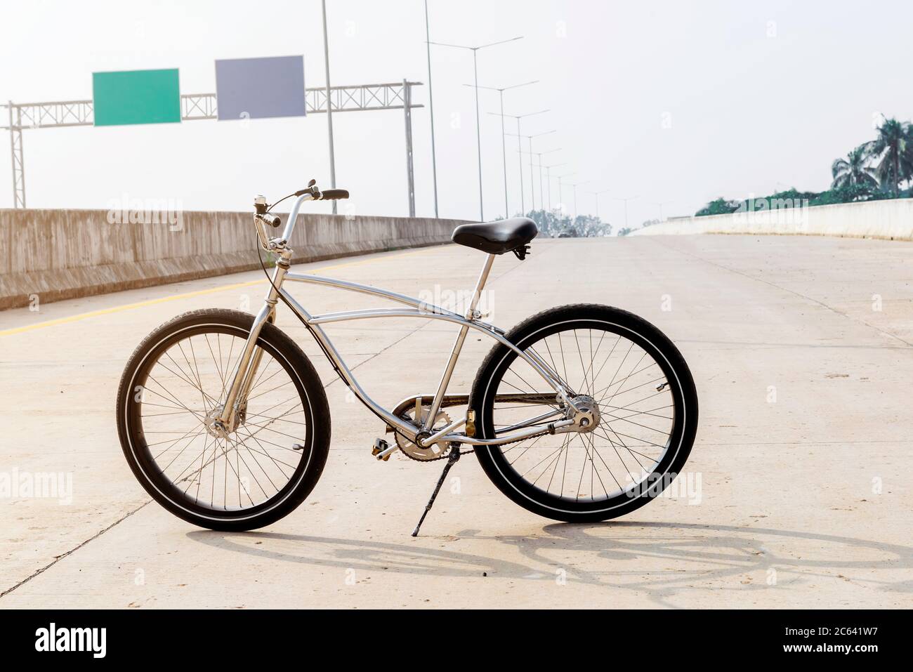 Bicycle on the road with a blue sky background Stock Photo - Alamy