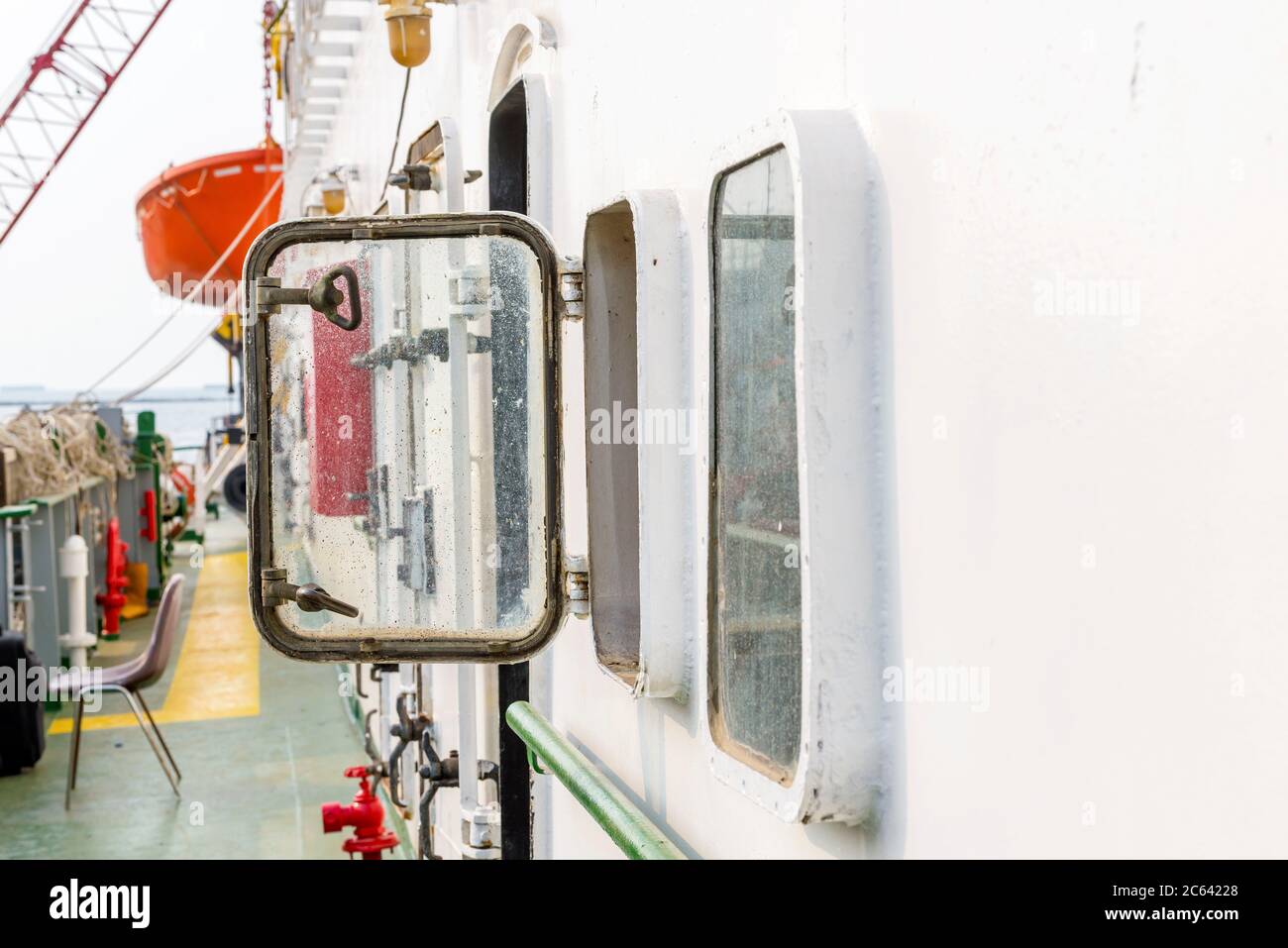 Side view of opened a window in the ship Stock Photo - Alamy