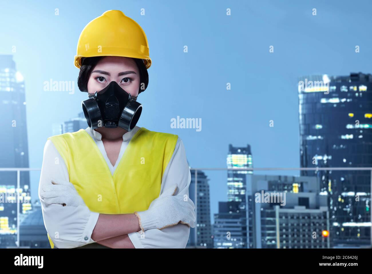 Asian construction worker with hardhat and safety mask standing with ...