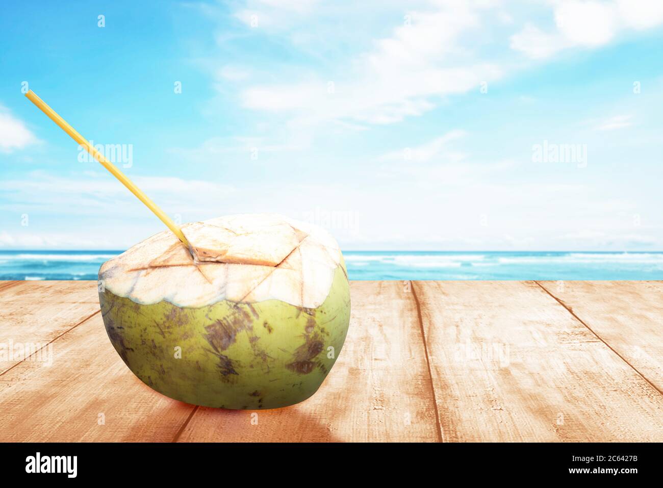 Coconut fruit on the table with ocean view background Stock Photo - Alamy