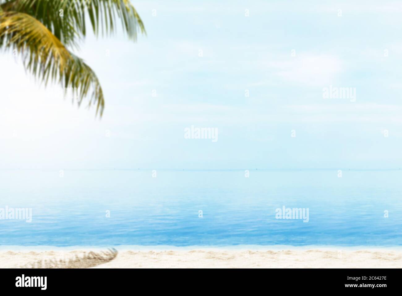 Sandy beach with the blue ocean and blue sky background Stock Photo - Alamy