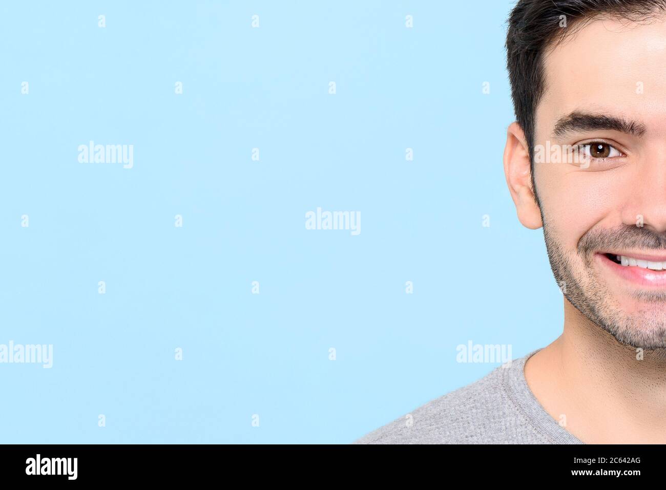 Half face close up of young handsome caucasian man smiling isolated on ...
