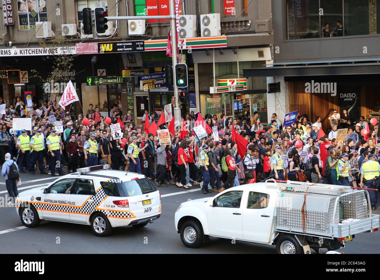 Student protesters march along George Street in Sydney. One of the ...