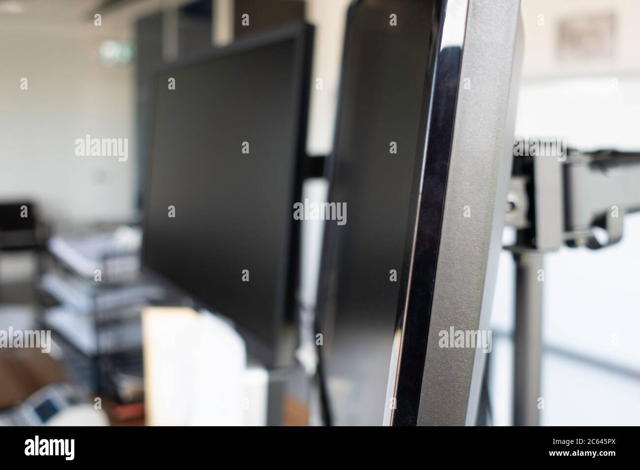 Pair of compter monitors set up in a business office Stock Photo - Alamy
