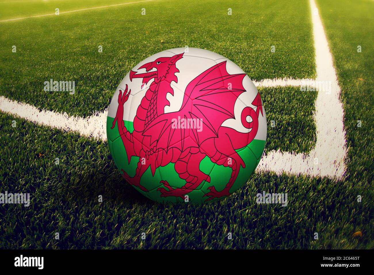 Wales flag on ball at corner kick position, soccer field background ...