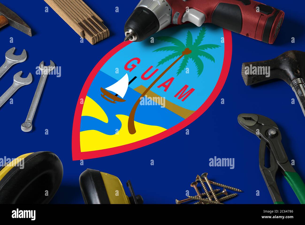 Guam flag on repair tool concept wooden table background. Mechanical ...