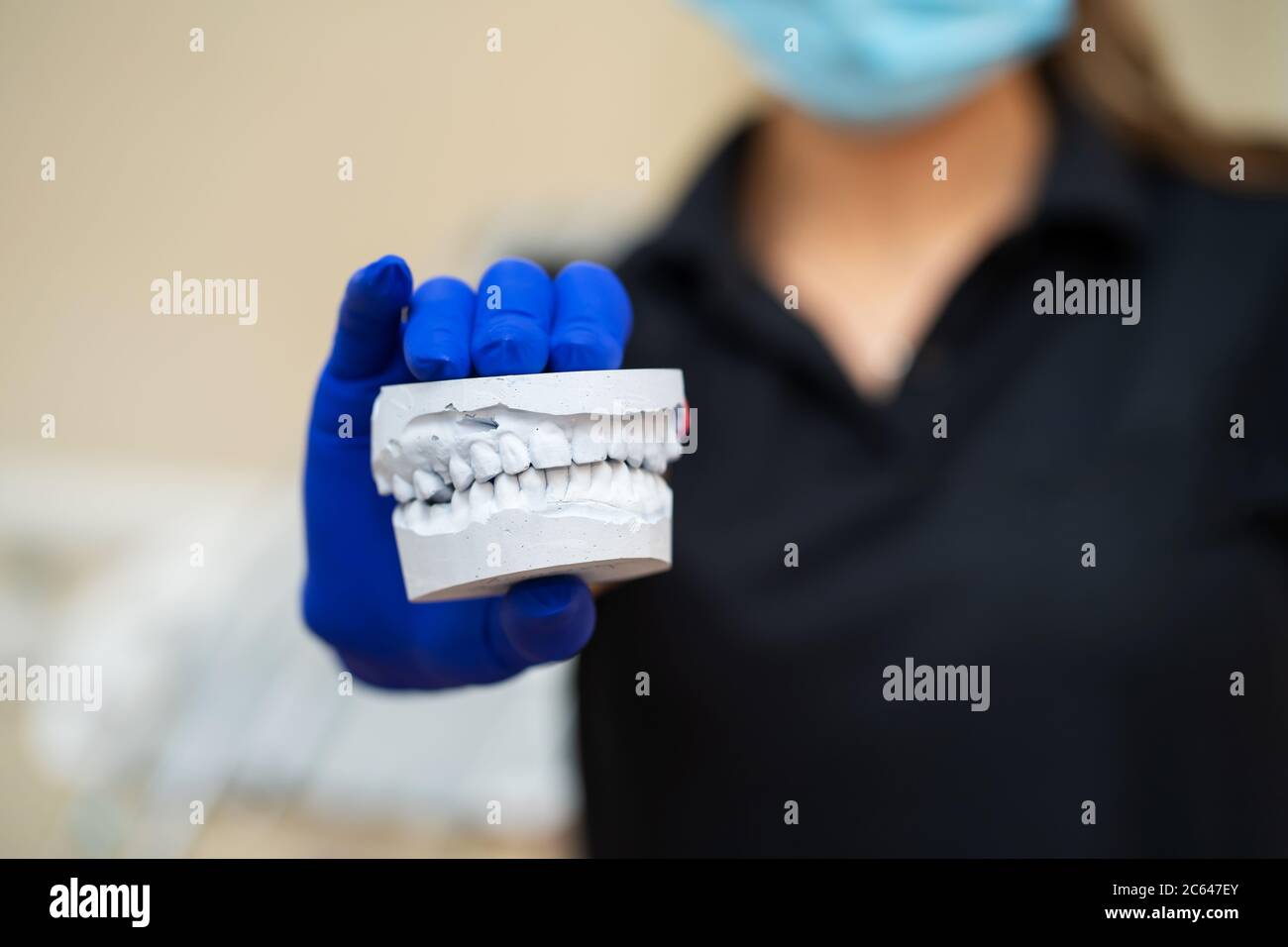 Beautiful girl professional doctor dentist orthodontist shows a plaster ...