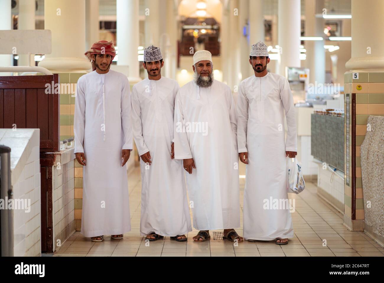 Nizwa / Oman - February 15, 2020: Group of four men wearing traditional ...