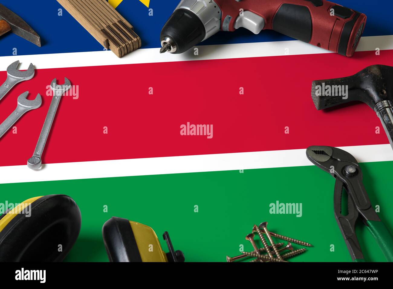 Namibia flag on repair tool concept wooden table background. Mechanical ...