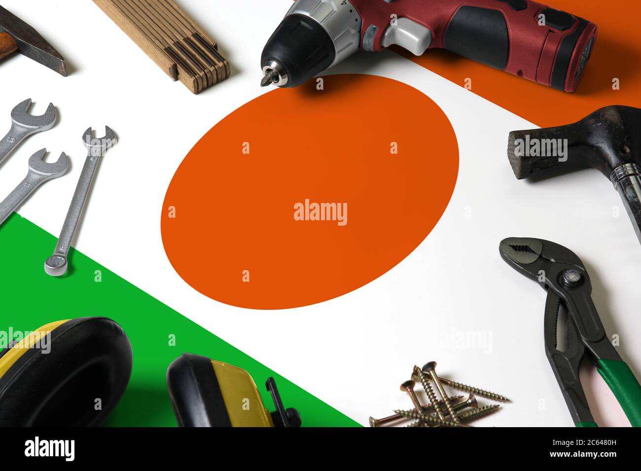 Niger flag on repair tool concept wooden table background. Mechanical ...