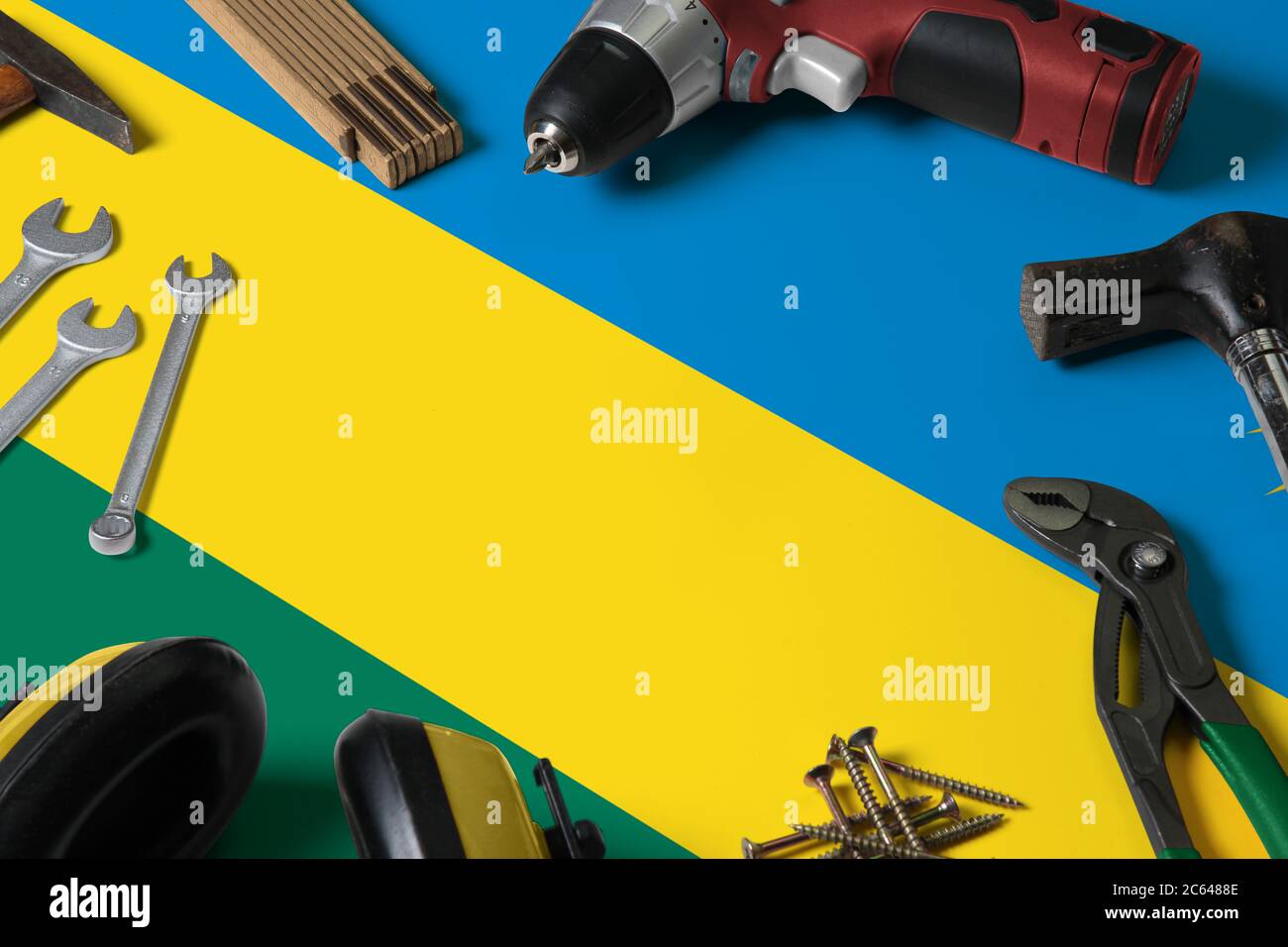 Rwanda flag on repair tool concept wooden table background. Mechanical ...
