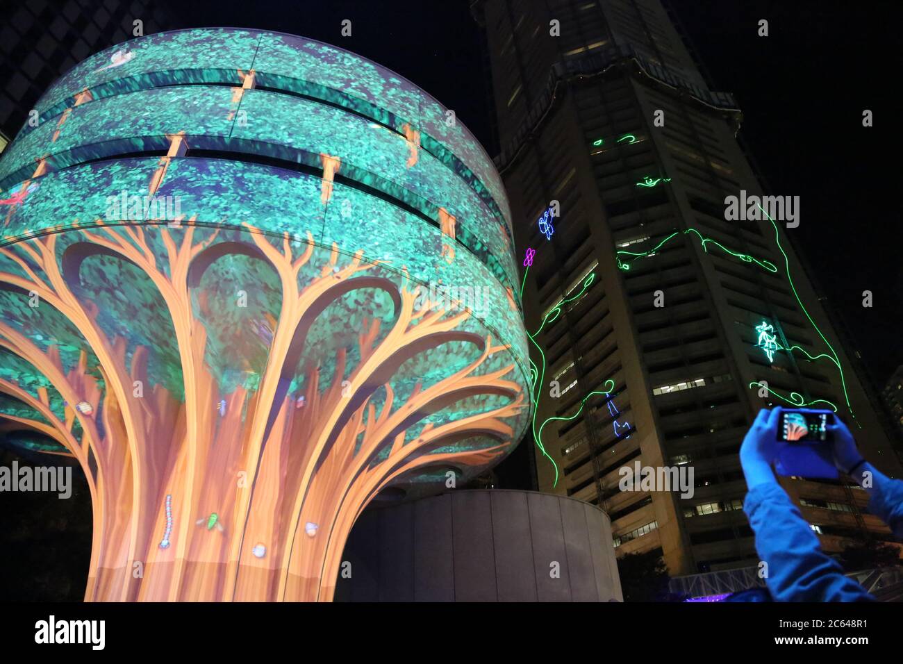 People take photos of buildings in Martin Place lit up for the Vivid ...