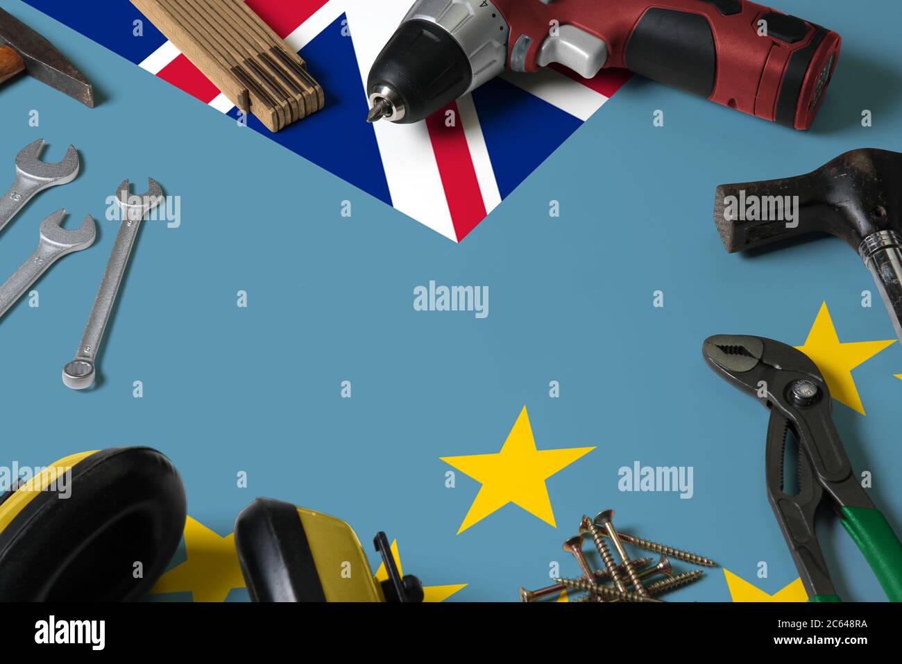Tuvalu flag on repair tool concept wooden table background. Mechanical ...