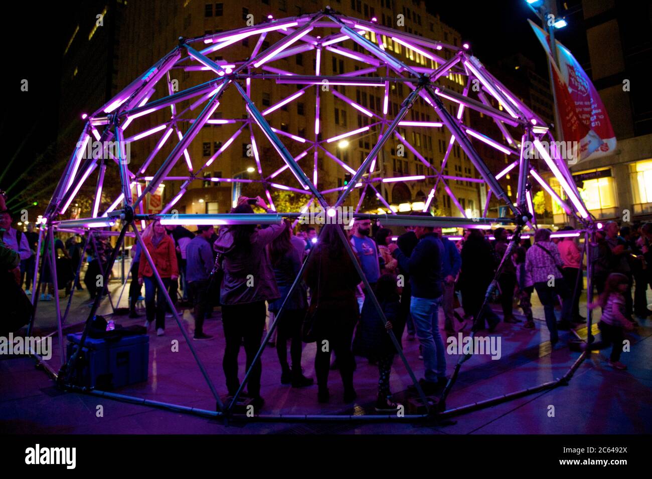 People have a look inside a structure in Martin Place, which is lit up ...