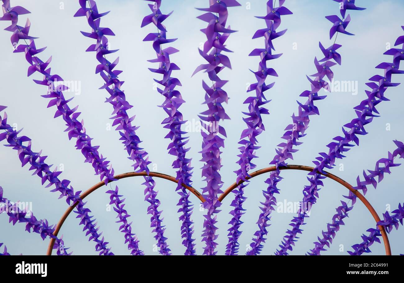 Purple windmills arranged in an outdoor arrangement Stock Photo - Alamy